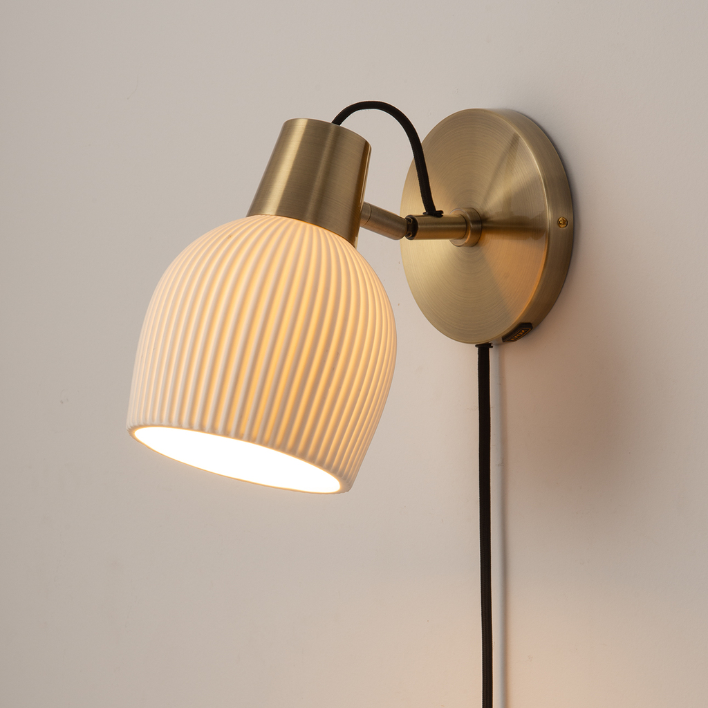 Petaluma Bone Porcelain Plug-in Wall Sconce In Weathered Brass by Nova ...